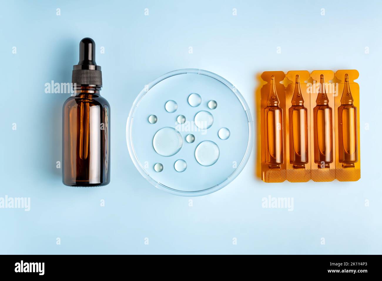 Set of plastic ampoules with dropper bottle and petri dish with drops ...