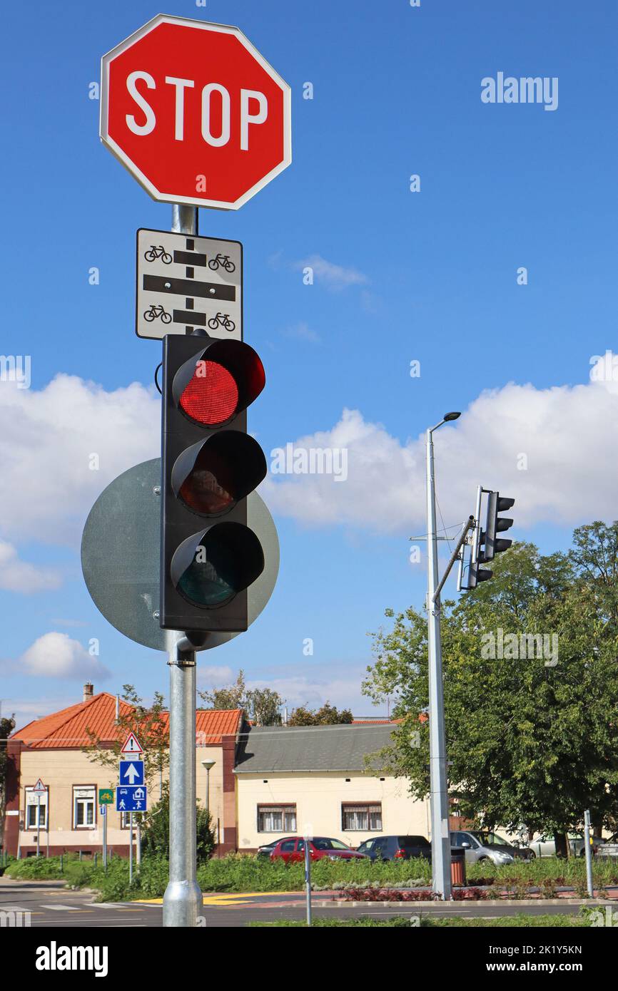 Red traffic light and stop sign at the road crossing Stock Photo - Alamy