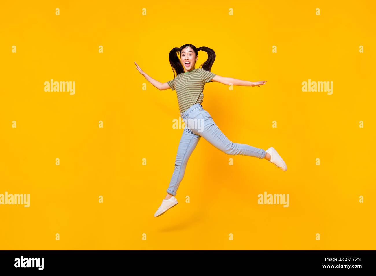 Full body photo of young cheerful girl playing active energetic game ...