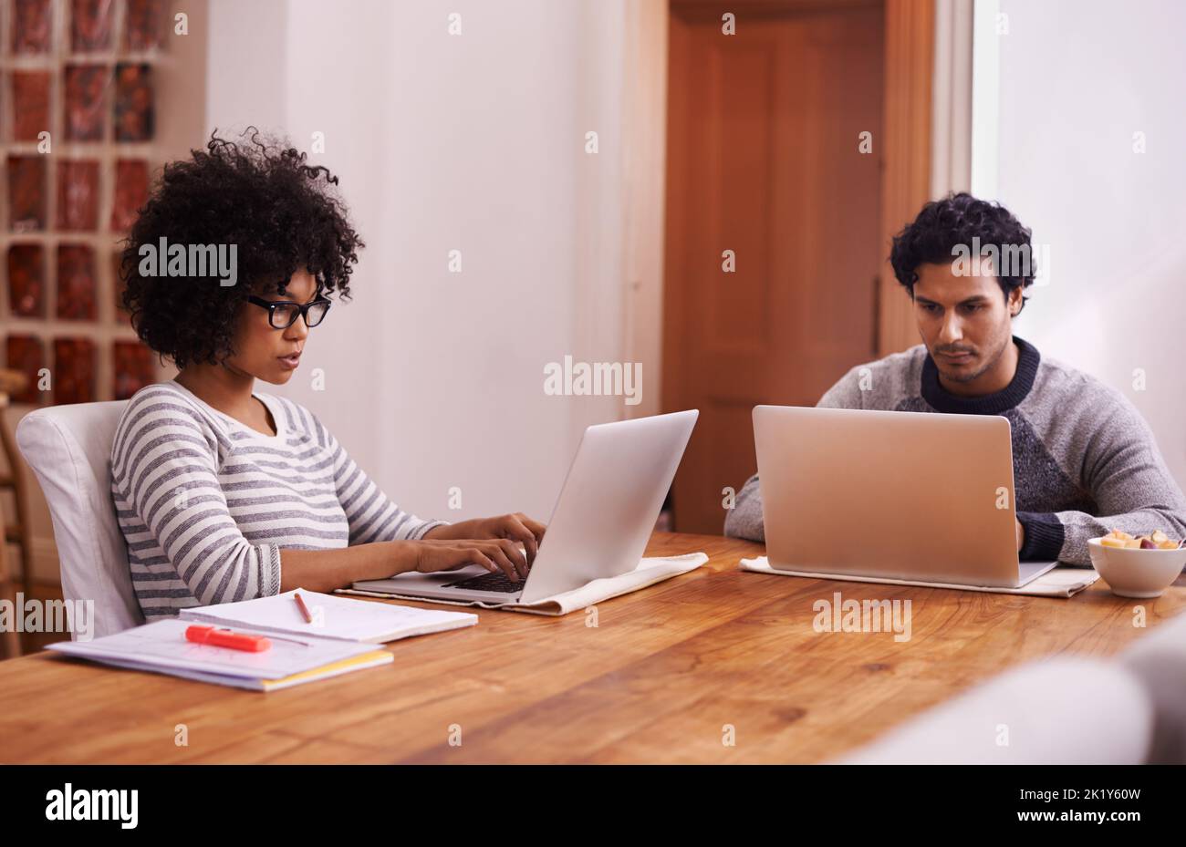 Life online. a young couple busy on their laptops at home Stock Photo ...