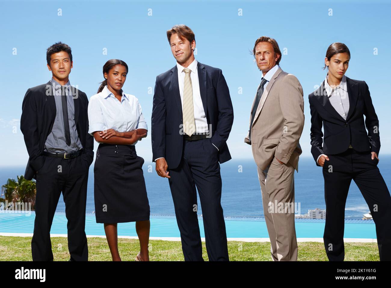 Feeling fierce under the sun. business people standing together in ...