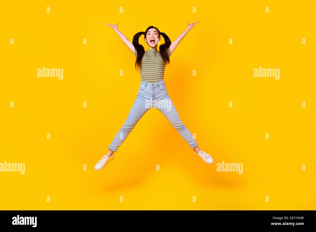 Full length photo of young good mood pretty female jumping up go crazy ...