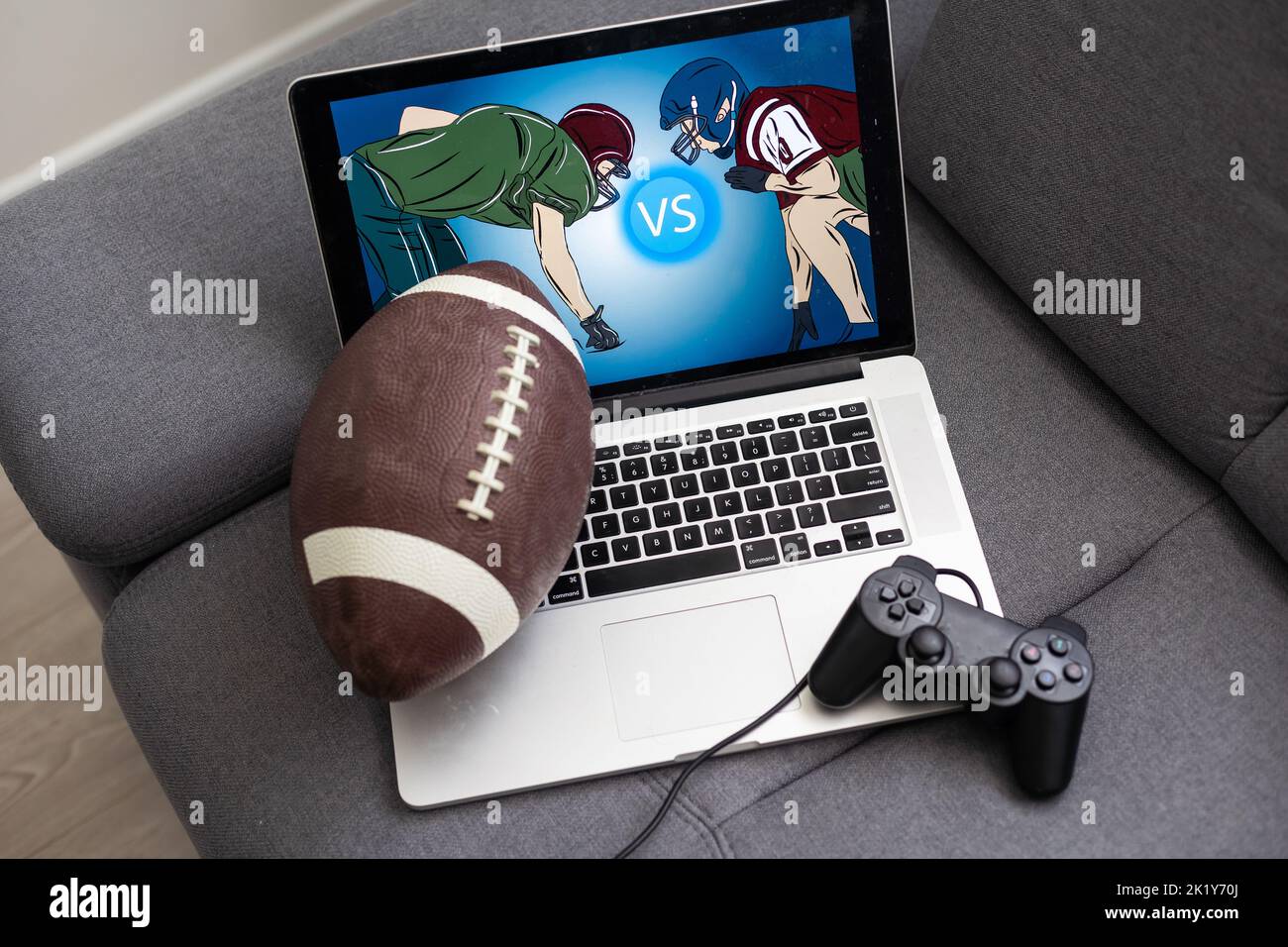 American football ball and joystick. video game Stock Photo - Alamy