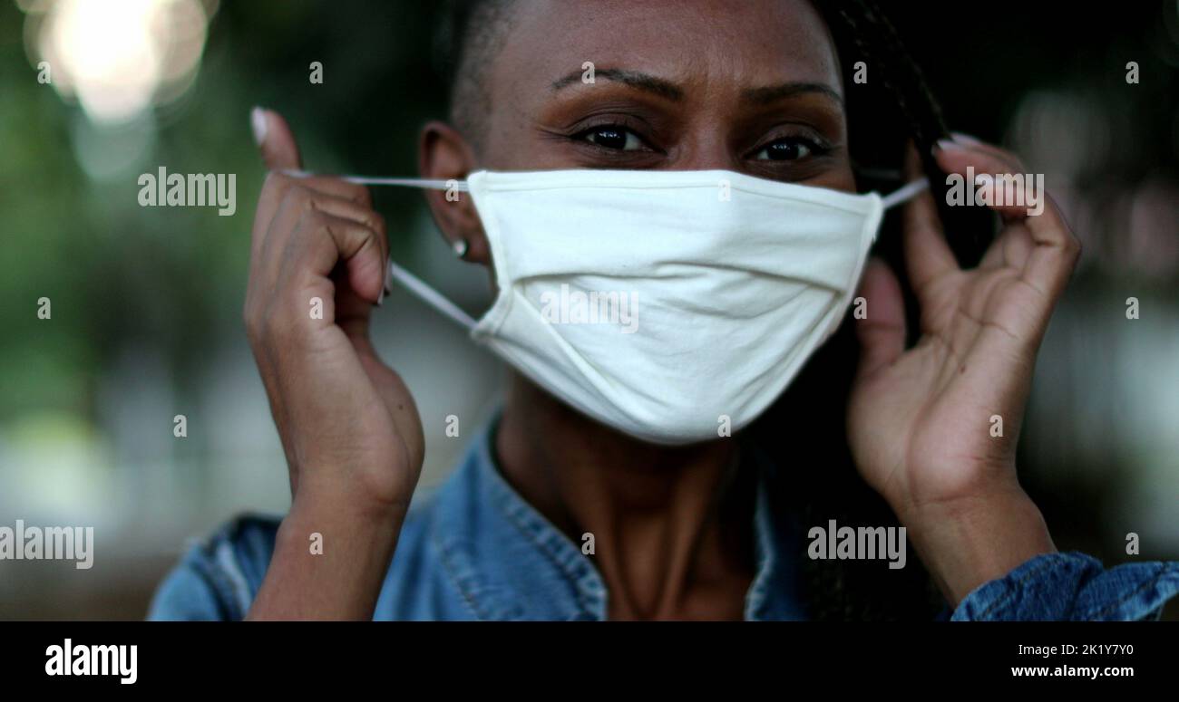 Black woman taking off covid face mask celebrating end of pandemic ...