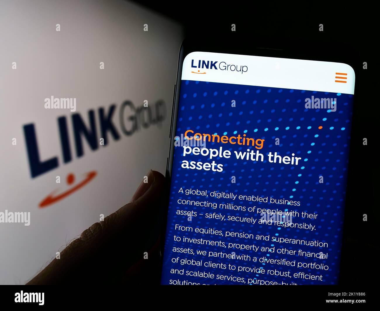 Person holding cellphone with website of Australian financial company ...