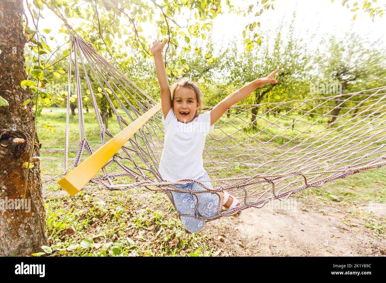 A little girl lying on a hammock hi-res stock photography and images ...