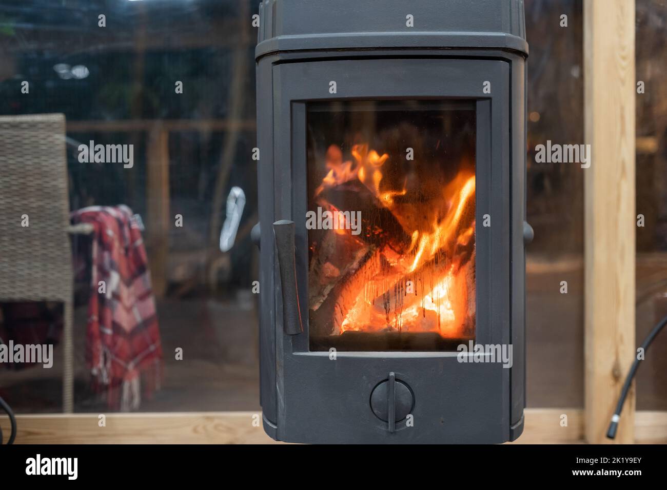 Concept of fireplace with fire at home. Comfortable living room with ...