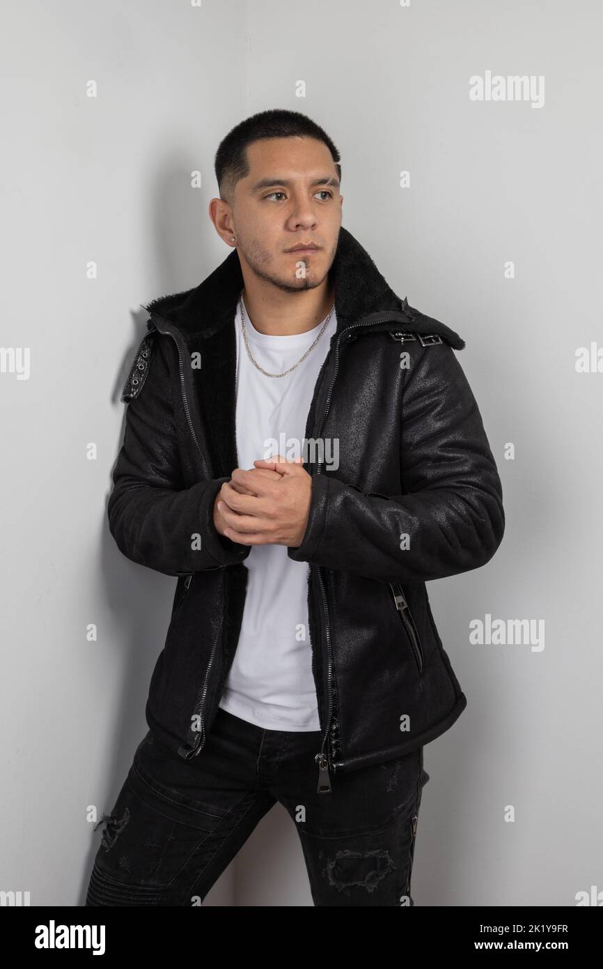 latin young man modeling trendy modern clothes, wears a leather jacket ...