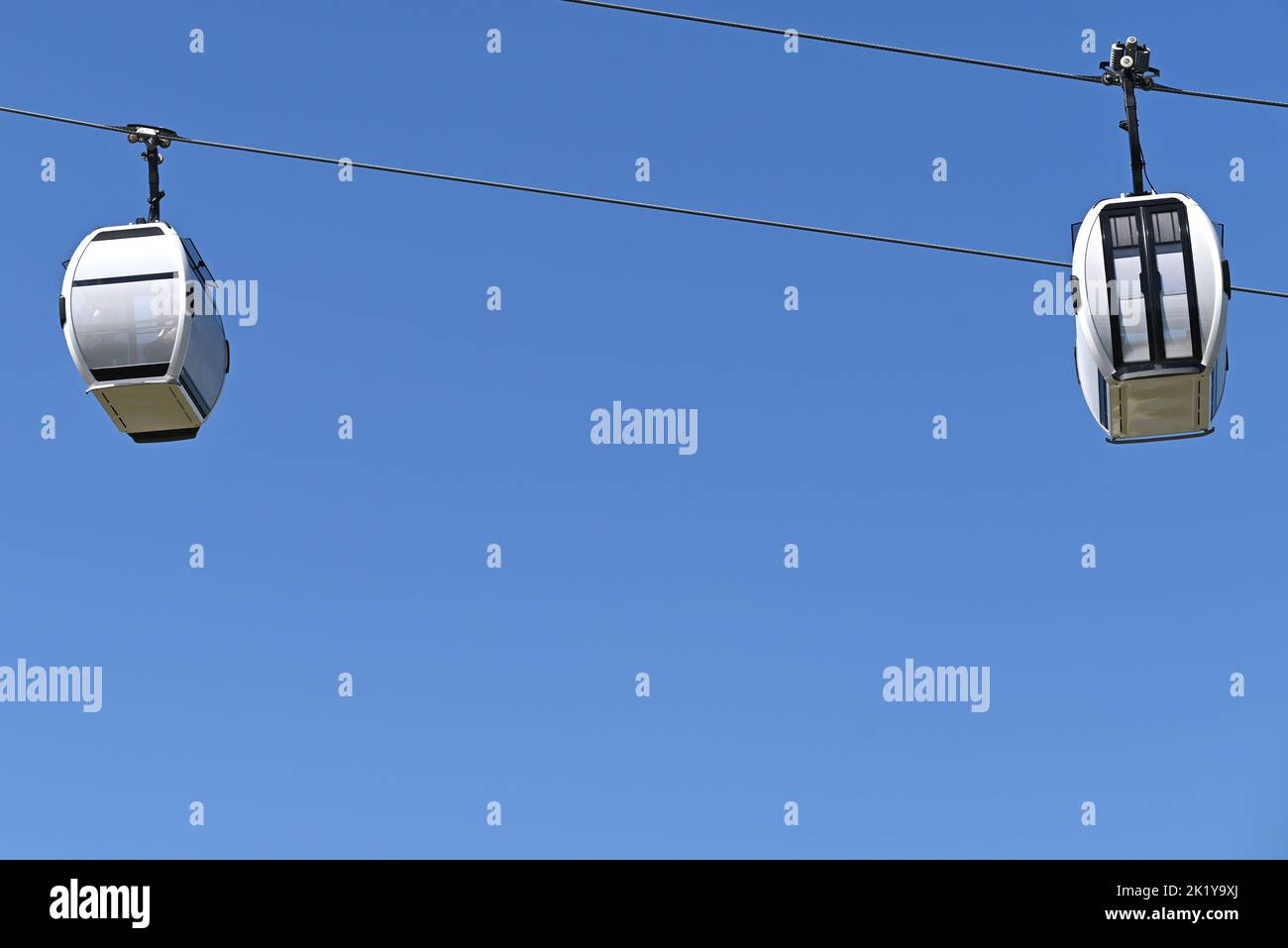 A white cable-car with a blue background Stock Photo - Alamy