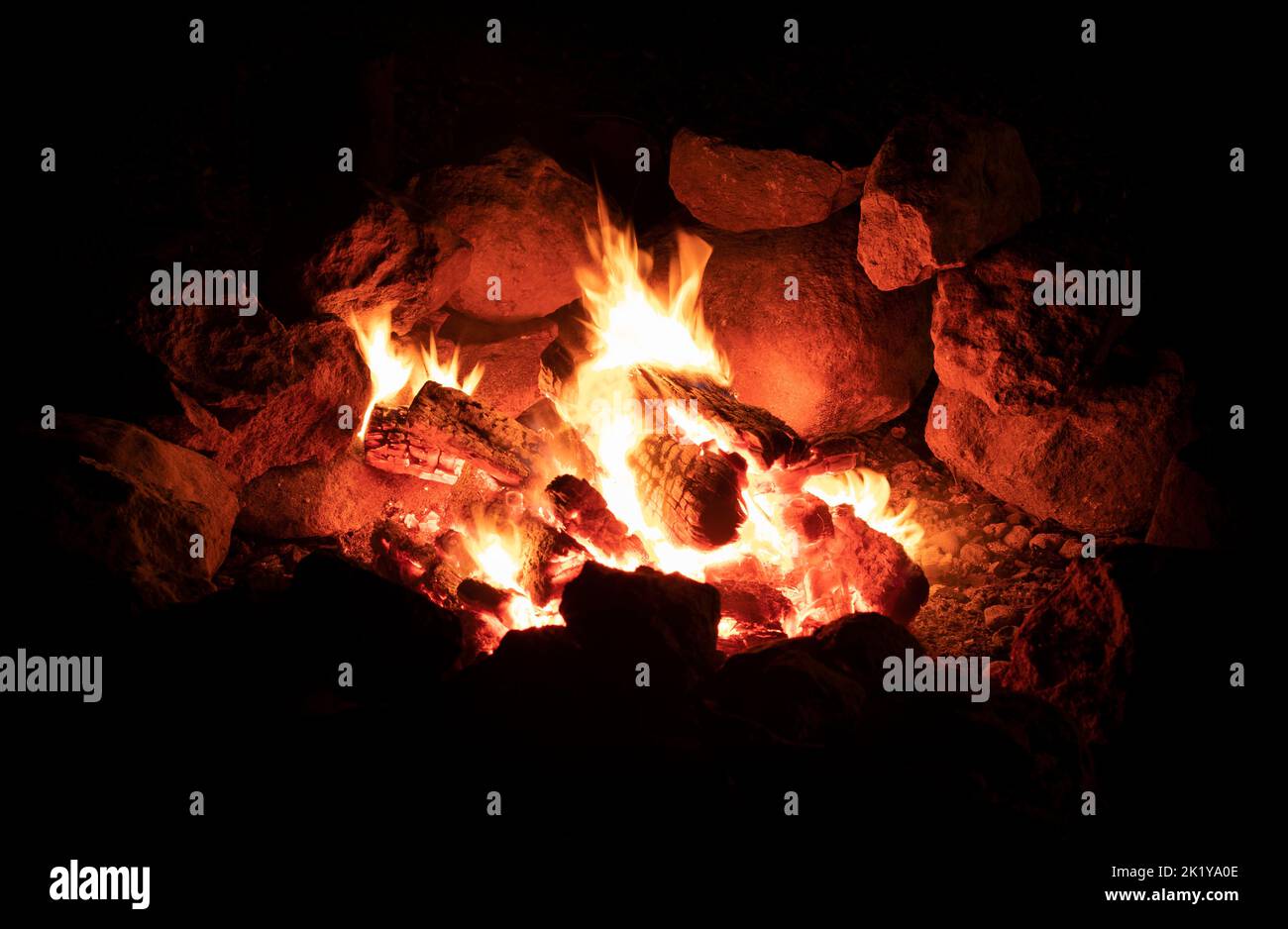Campfire that is burning very hot surrounded by rocks Stock Photo - Alamy