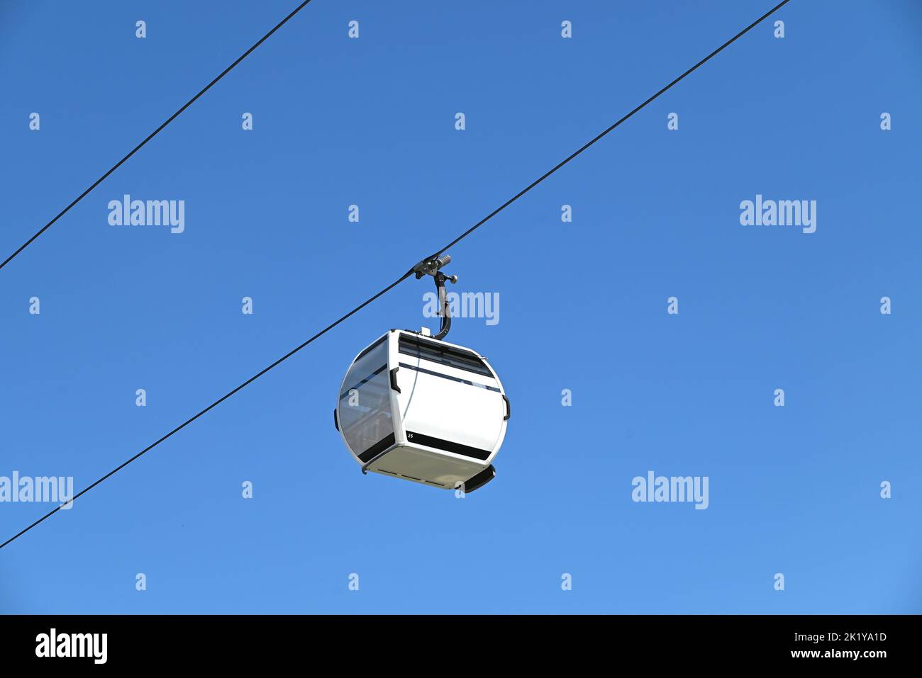 A white cable-car with a blue background Stock Photo - Alamy