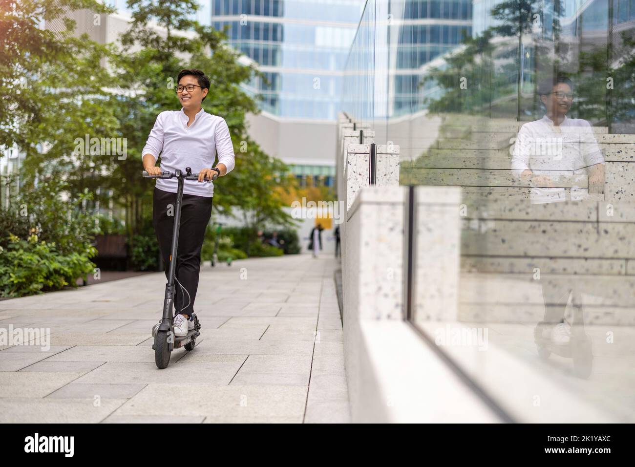 Riding electric scooter hi-res stock photography and images - Alamy