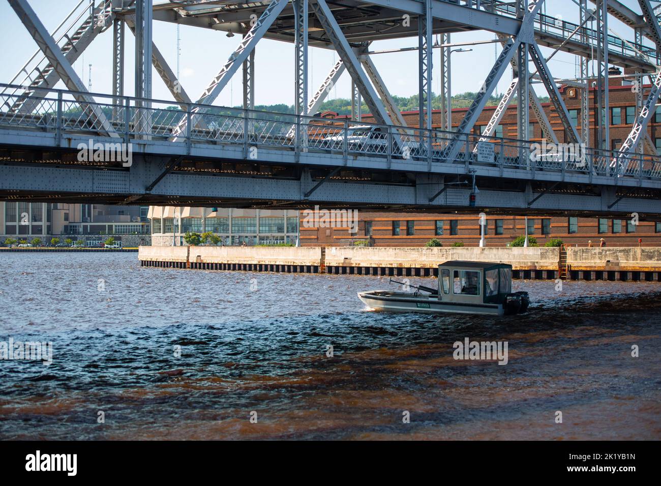 A small boat sailing under the Duluth Aerial Lift Bridge during the ...