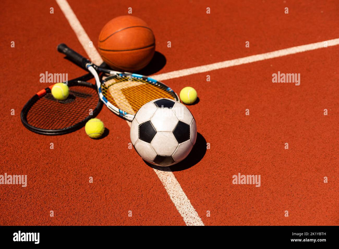 A group of sports equipment on black background including tennis ...