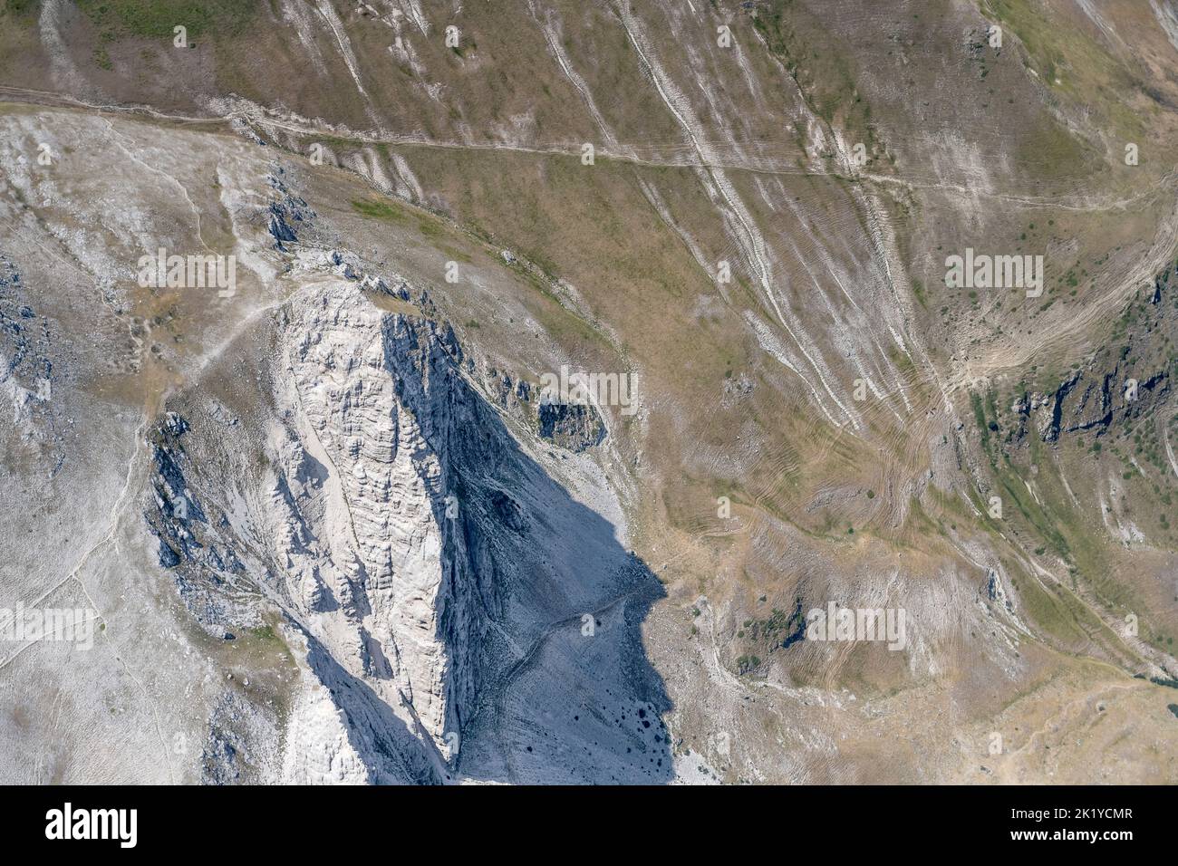 aerial shot, from a small plane, of steep crags and barren slopes at ...