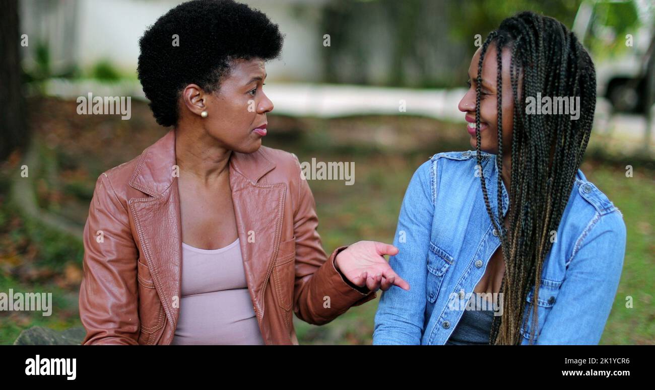 Two African women talking outside. People conversation at park Stock ...