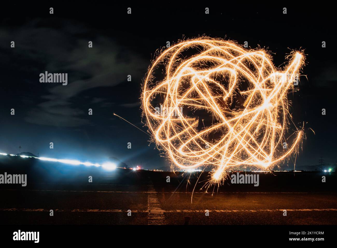 Steel wool photography light painting at night Stock Photo - Alamy