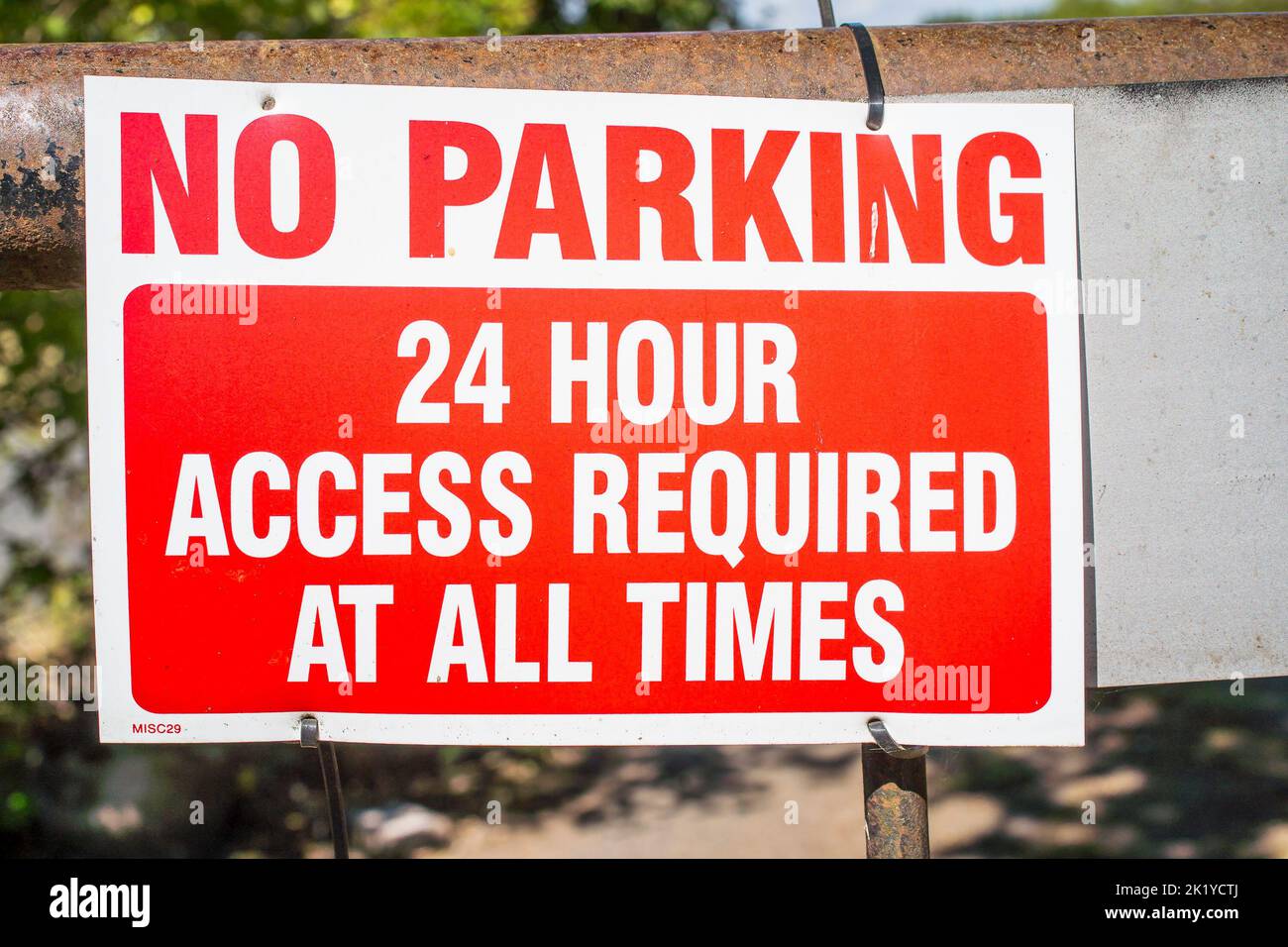 Close up of red & white No Parking sign isolated on outdoor gate in UK ...