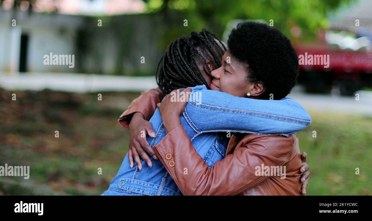 Two friends empathic hug. African women compassionate embrace Stock ...