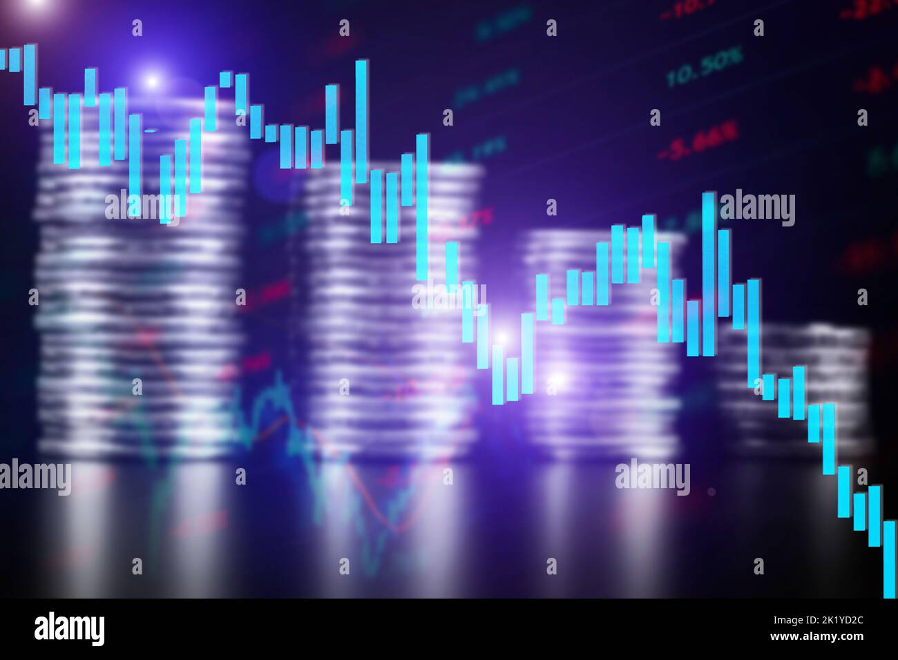 Graph of a falling stock market on the background of stacks of coins ...