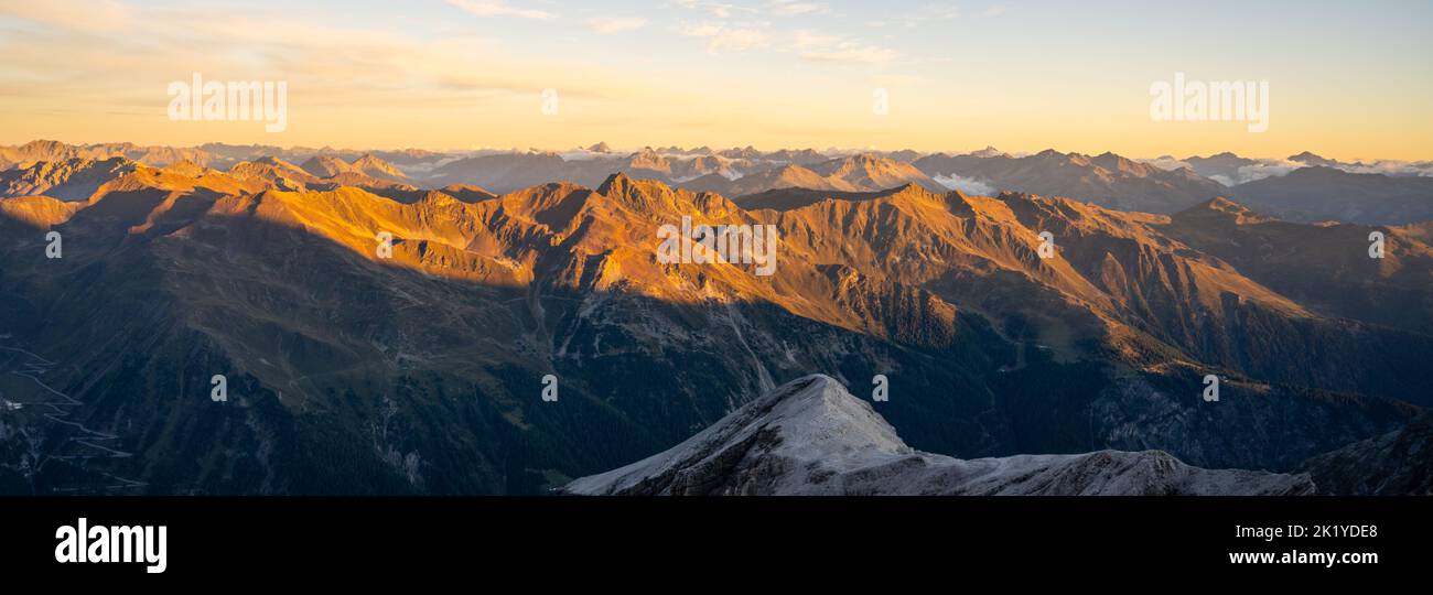 Alpine mountain peaks illuminated by rising sun Stock Photo - Alamy