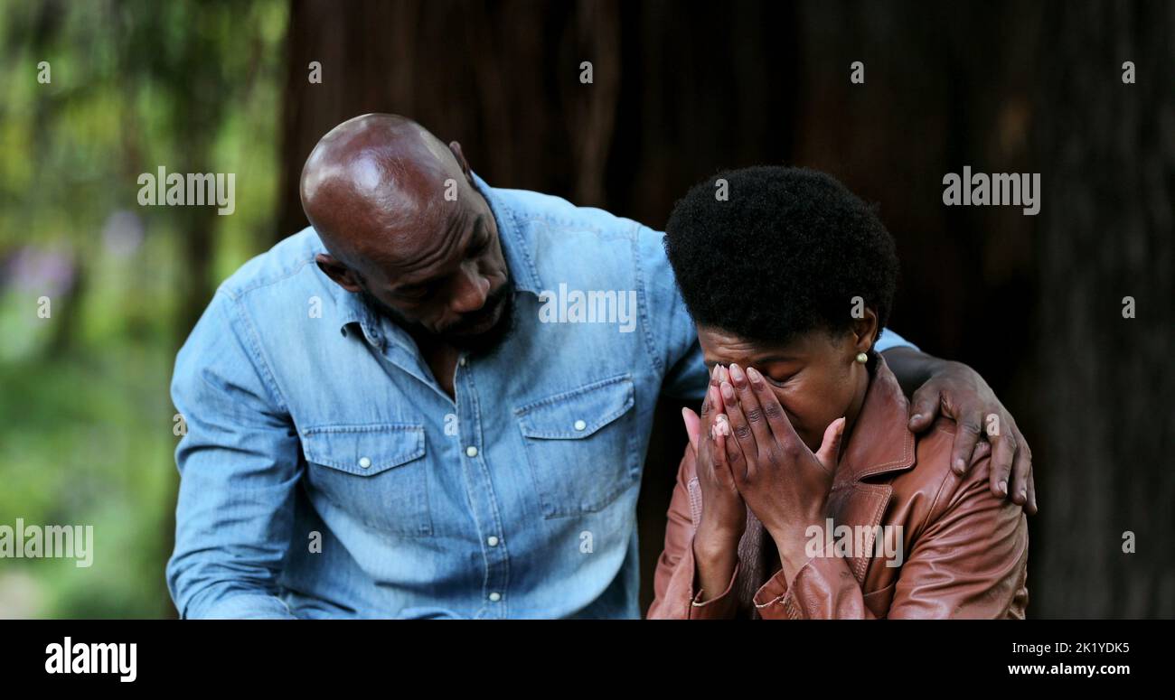 Man supporting partner wife through difficulties. African partner ...