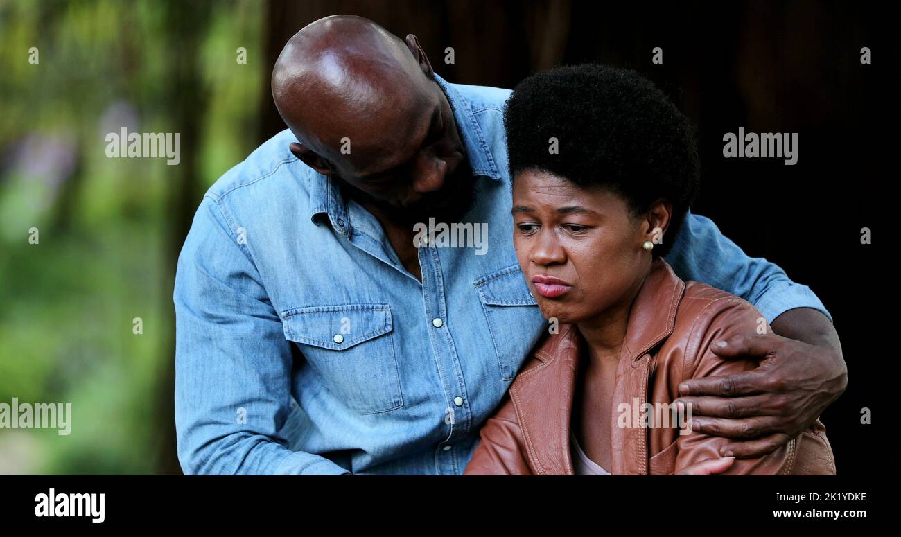 Man helping woman through emotional problems. African couple empathy ...