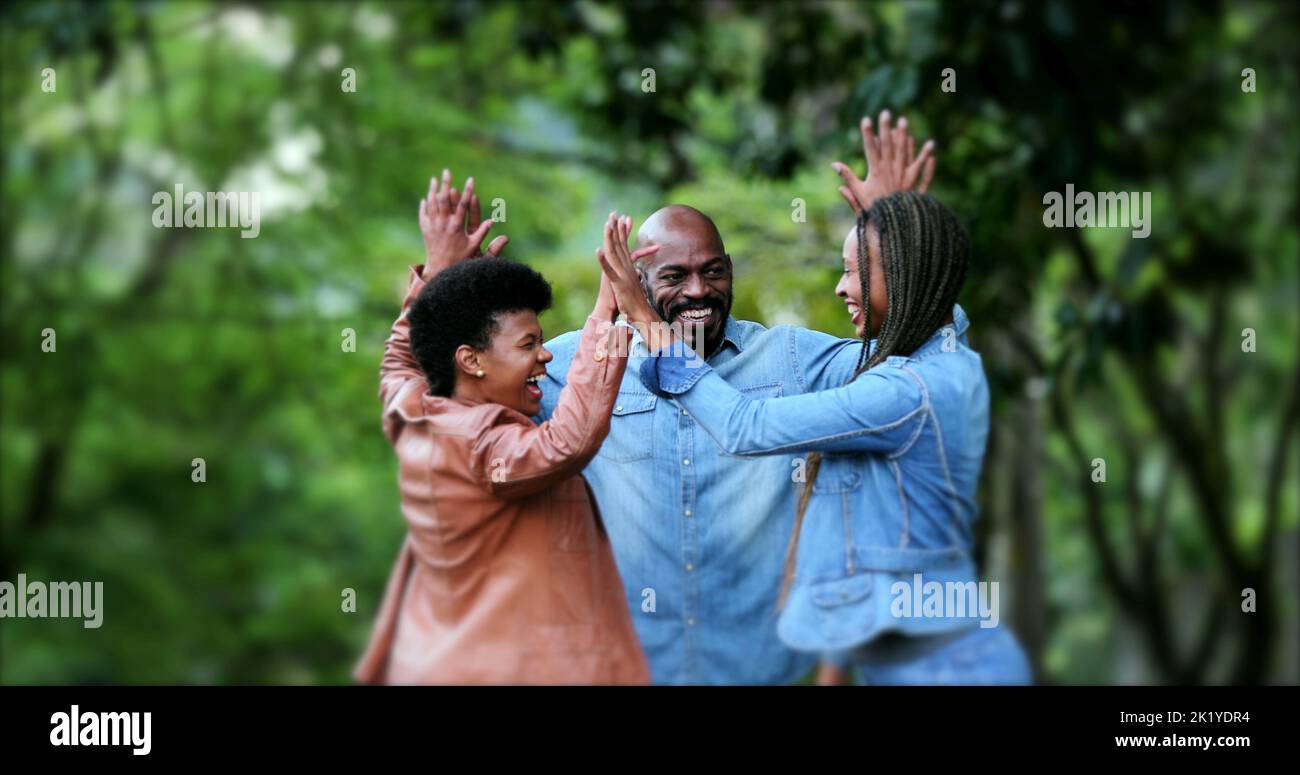 People building community group. three friends celebrating and hugging ...