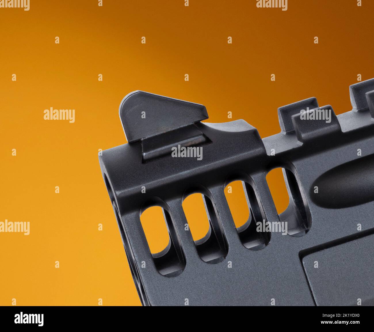 Ports and front sight on a large semi-automatic handgun with an orange ...