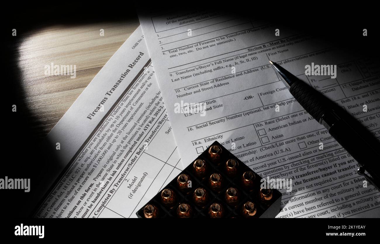 Public domain FBI NICS background check form on a table with cartridges ...
