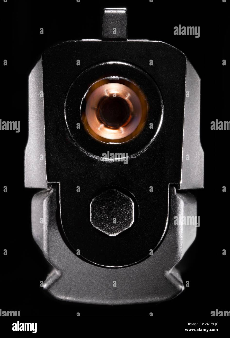 Semi-automatic handgun with bullet coming out of the barrel at the ...