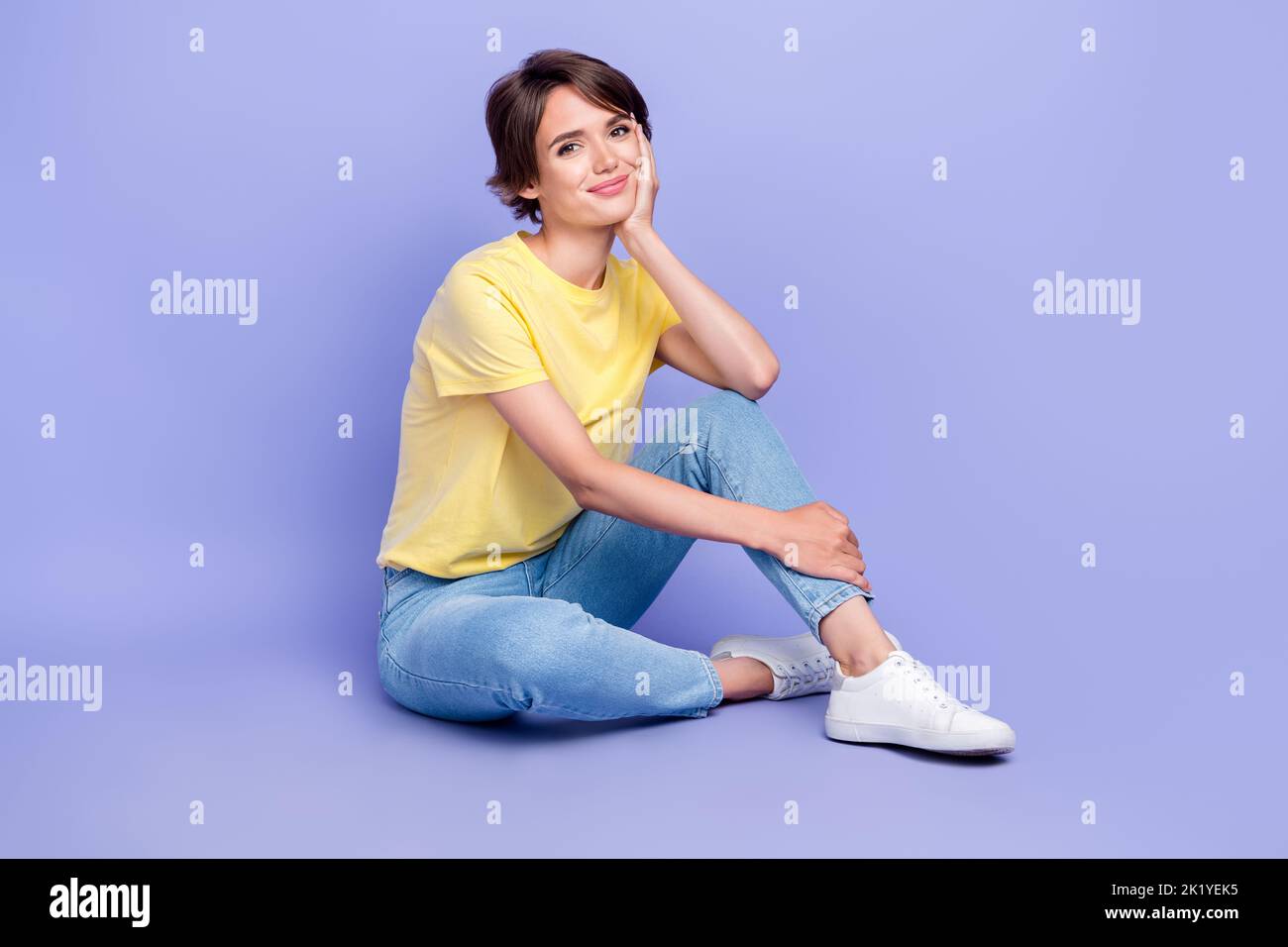 Full body photo of gorgeous satisfied lady sit floor hand touch cheek ...