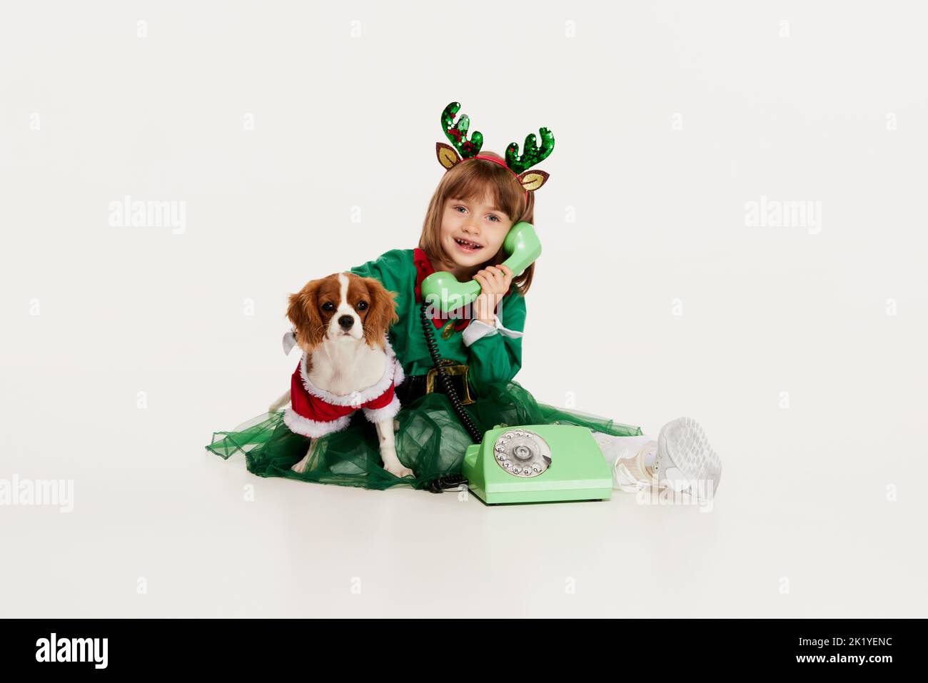 Portrait of beautiful little girl, child posing with dog isolated over ...