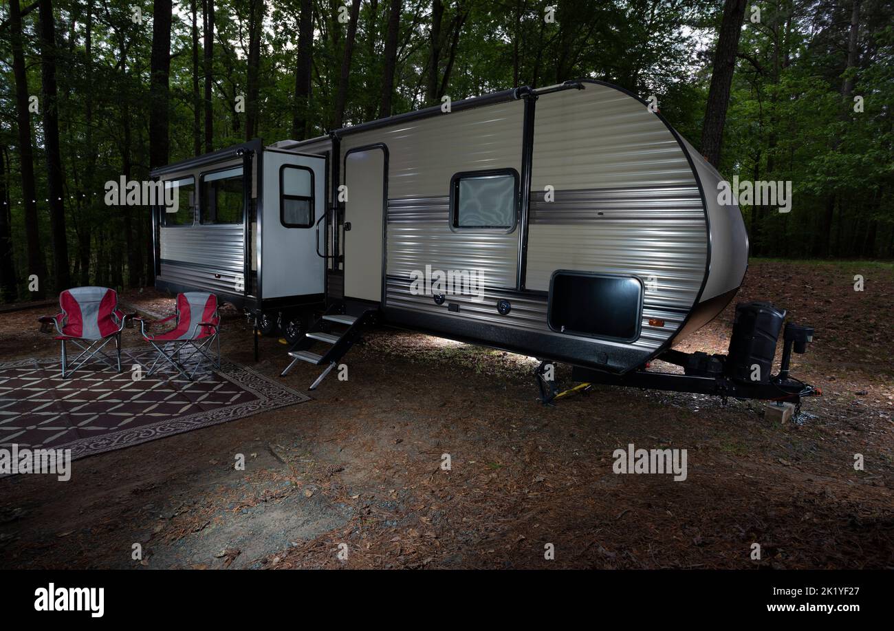 RV with two empty chairs at a campsite at Jordan Lake North Carolina ...