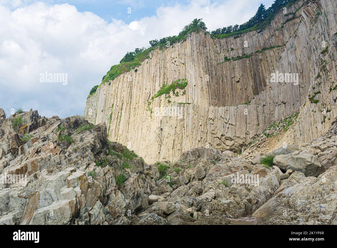 high coastal cliff formed by stone columns, Cape Stolbchaty on the ...