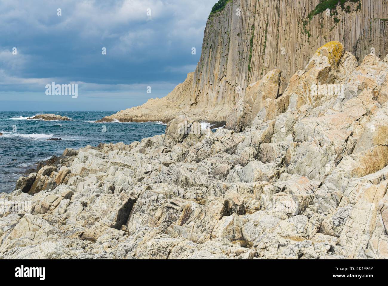 high coastal cliff formed by stone columns, Cape Stolbchaty on the ...