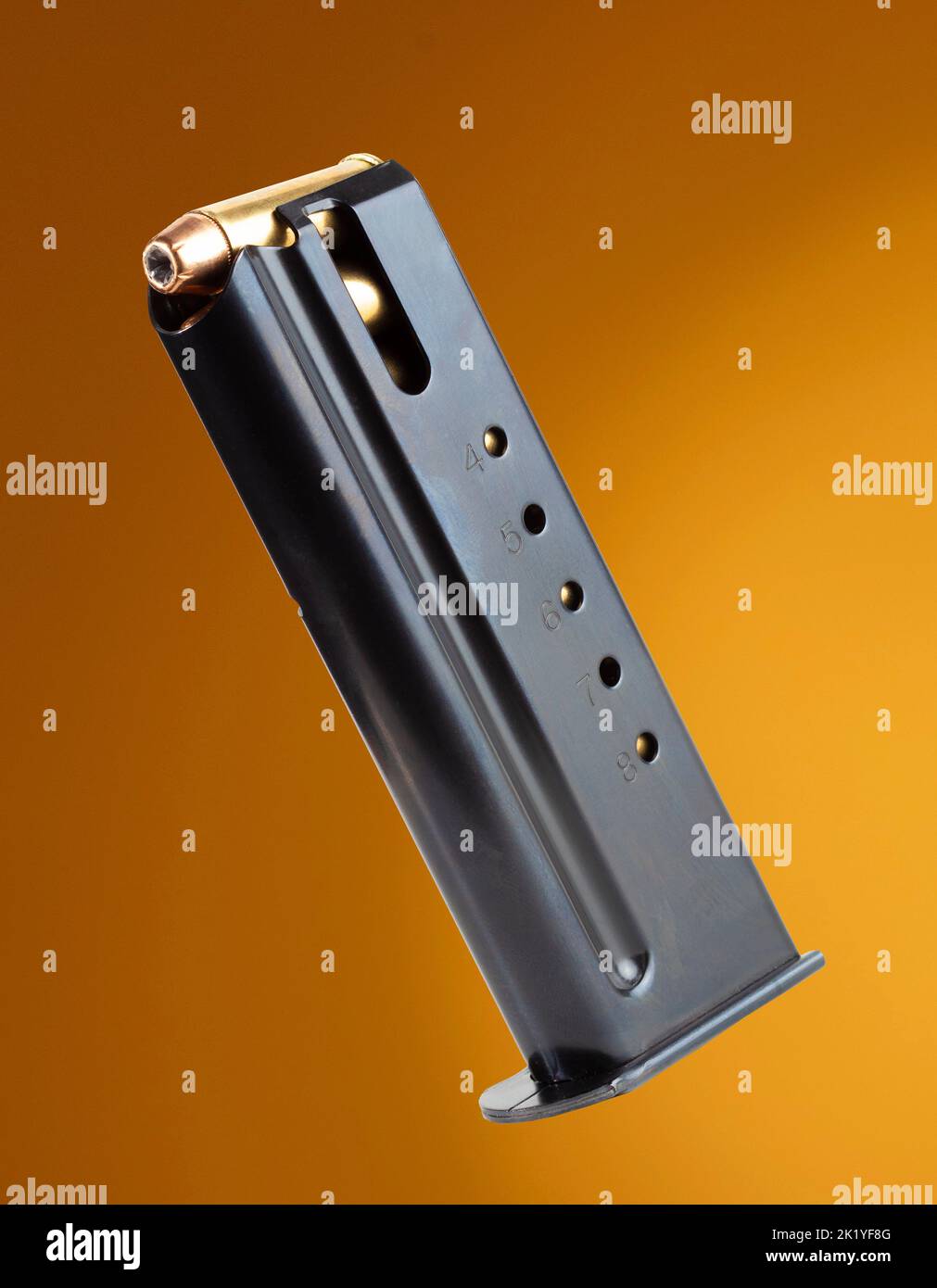 Handgun magazine with hollow points on an orange background Stock Photo ...