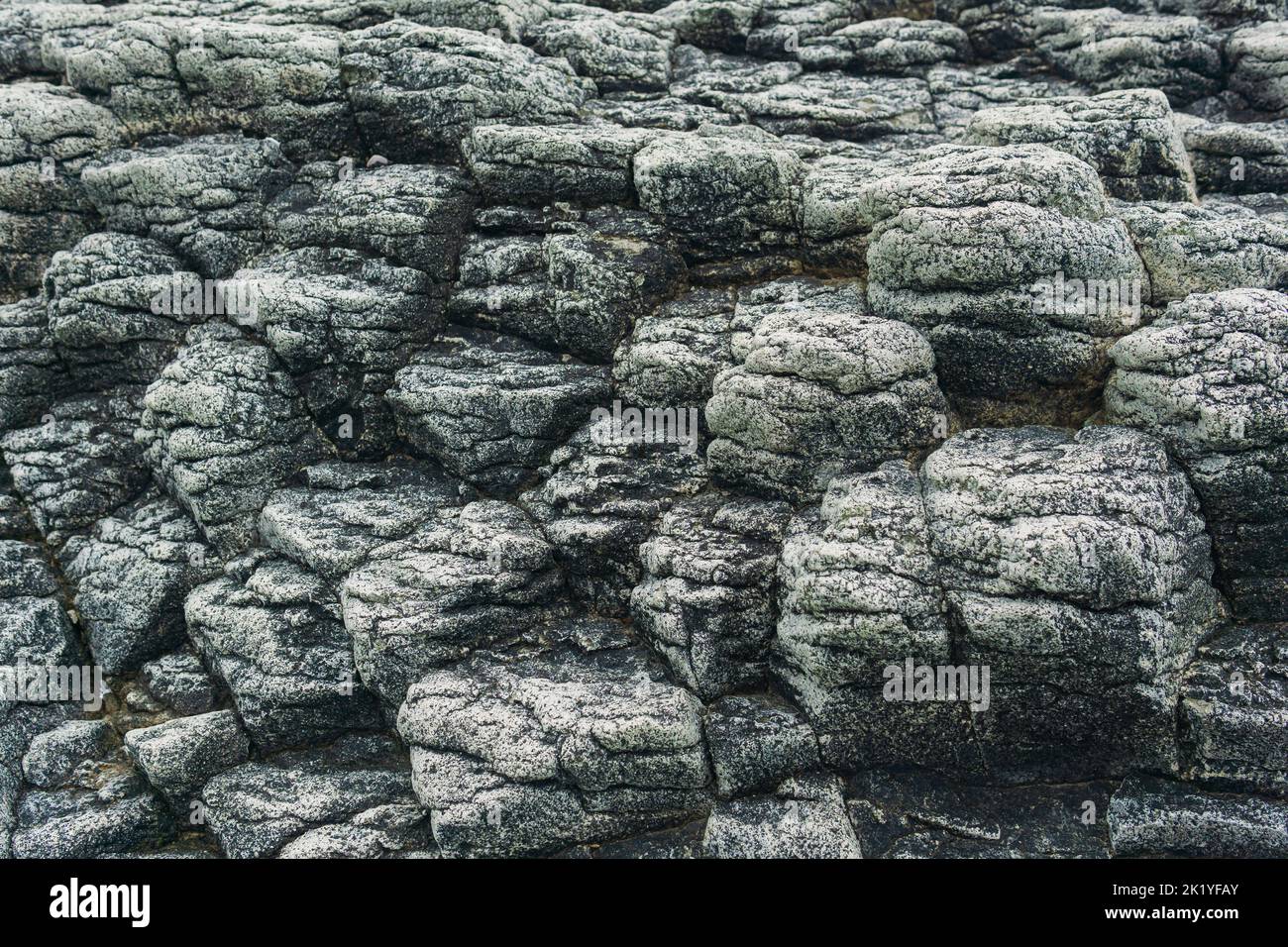 natural stone background, the remains of lava basalt columns form a ...