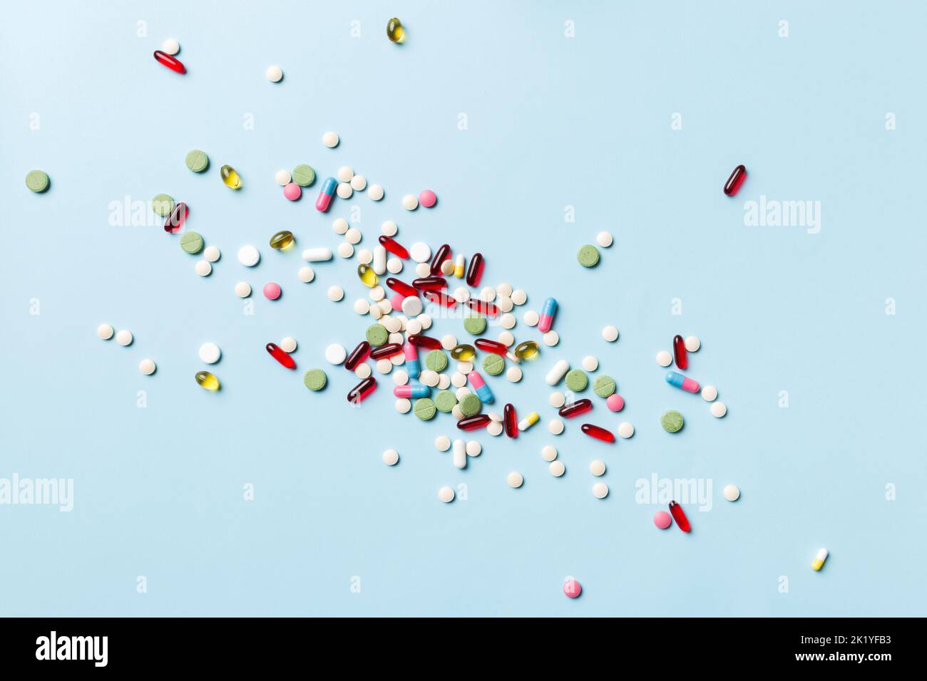 assorted pills and tablets top border over colored background. Many ...