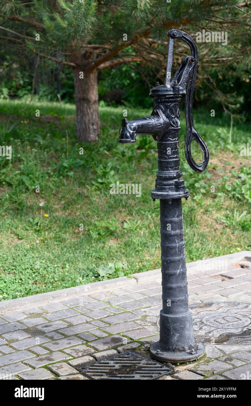Iron water tap pump of the 19th century on the street of the city of ...