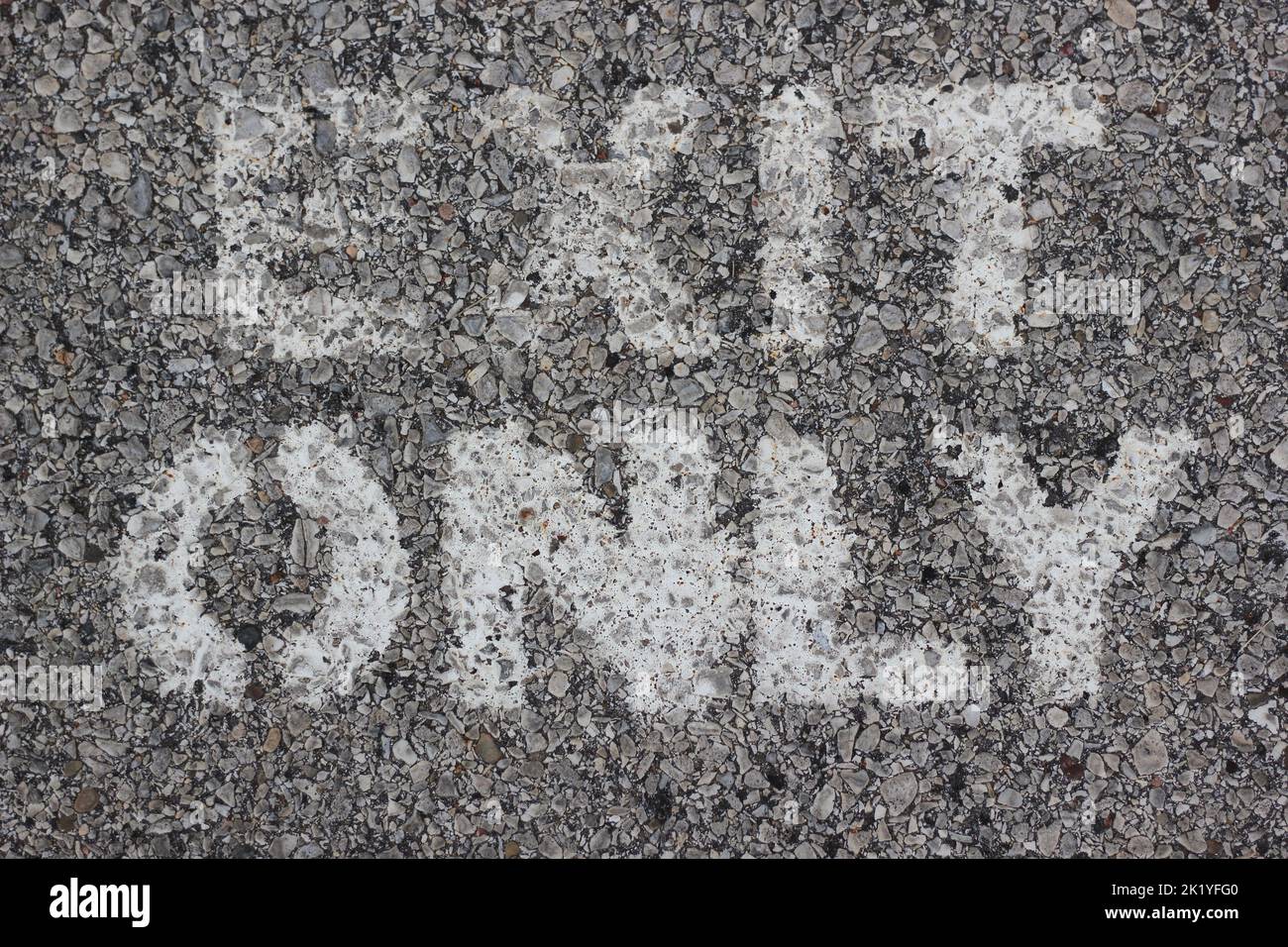 Exit only sign spray painted onto the asphalt Stock Photo - Alamy