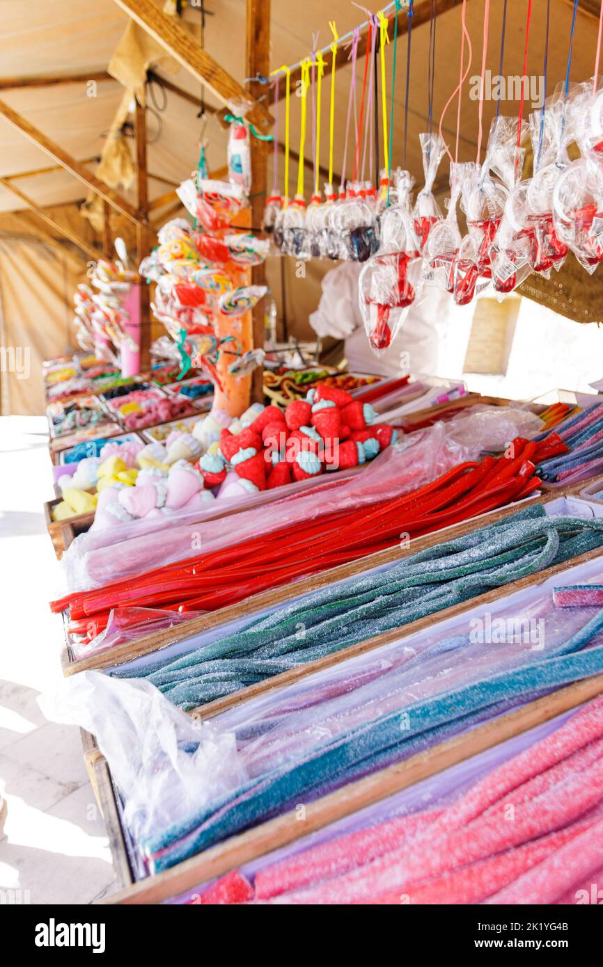 Sweets of many types and colors in a medieval market Stock Photo - Alamy