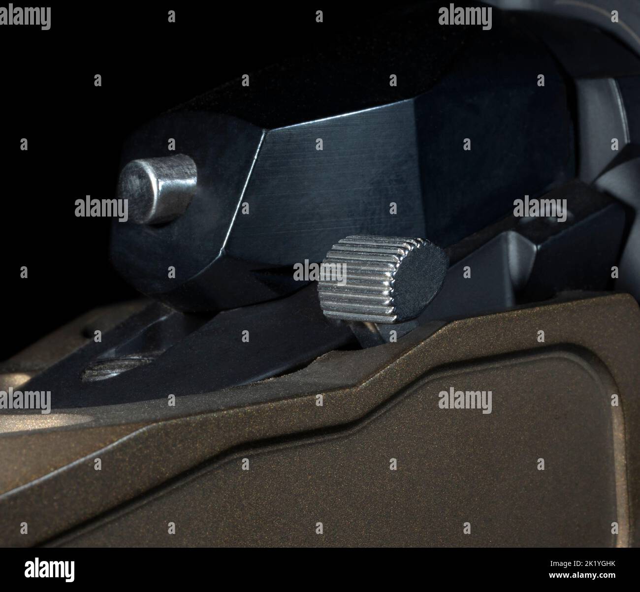 Safety engaged on a copper colored rifle with a black background Stock ...