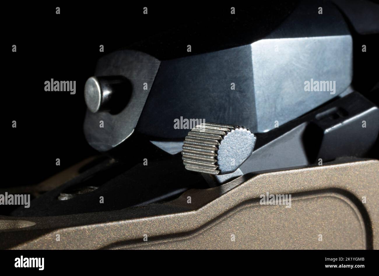 Safety that is activated on a bronze colored bolt-action rifle Stock ...