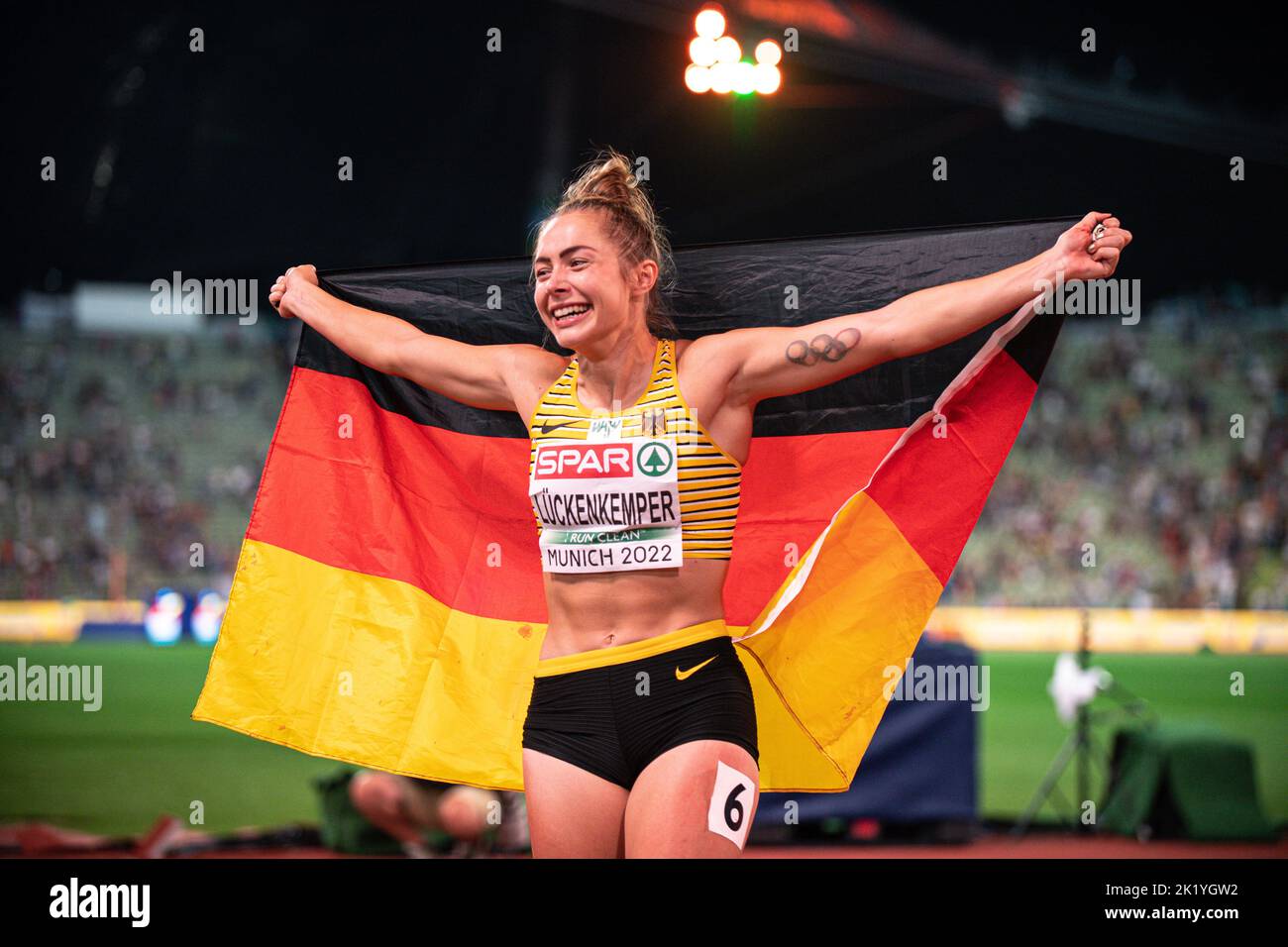 Gina Lückenkemper with her country's flag as the winner of the 100 ...