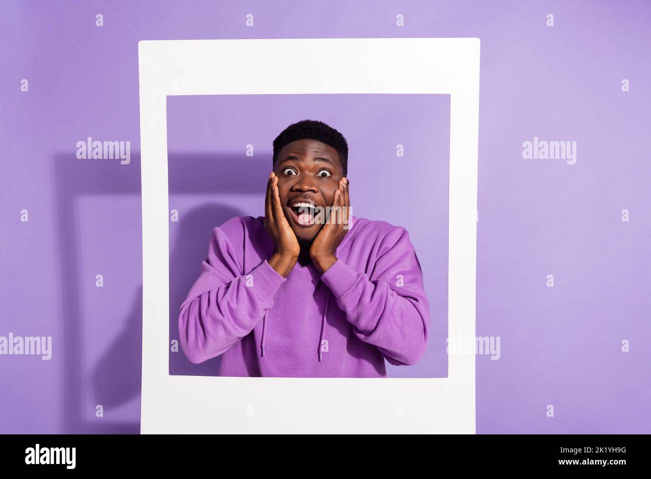 Portrait of astonished handsome guy arms cheekbones open mouth isolated ...