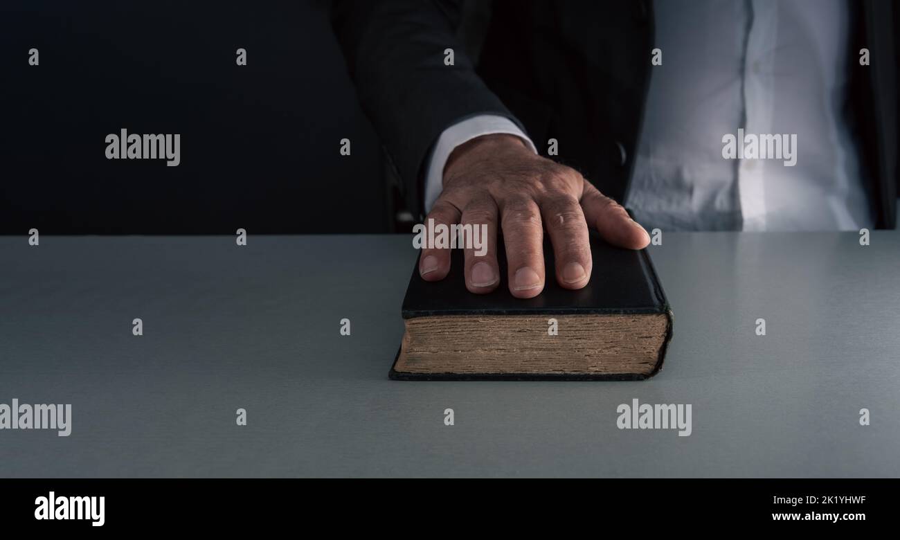Hand on black book ,swearing on the bible , concept of telling the ...