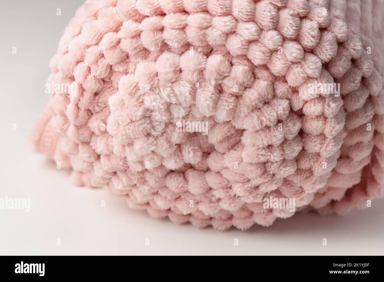 Roll up soft pastel pink fleece throw fabric with lines. White ...