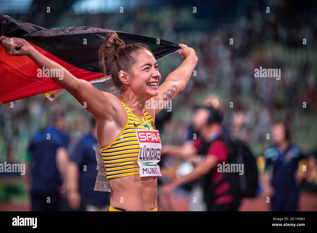 Gina Lückenkemper with her country's flag as the winner of the 100 ...
