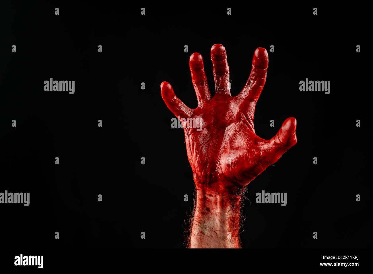 Male palm stained with blood on a black background Stock Photo - Alamy